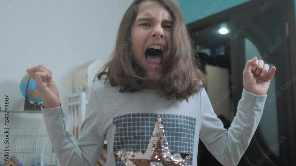 schoolgirl covering her face with her hands. emotion depression concept ...