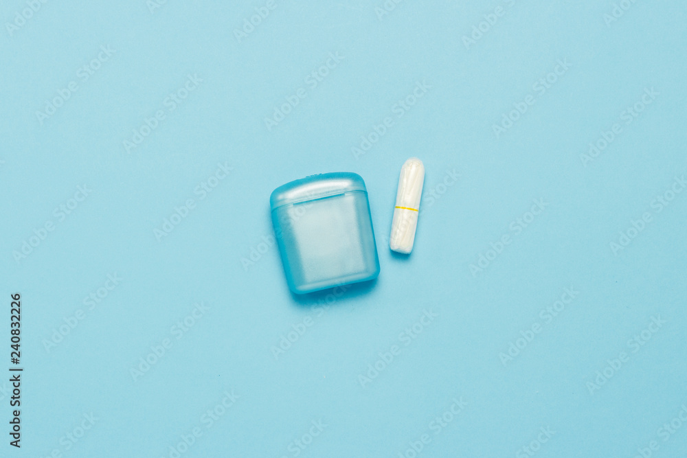 Feminine hygiene tampons and box for shipping and storage on a blue ...