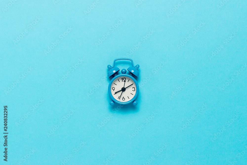 Blue alarm clock on a blue background. Concept day and night, time ...