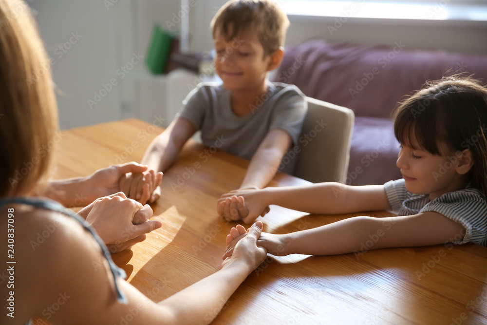 Family praying at home Stock Photo | Adobe Stock