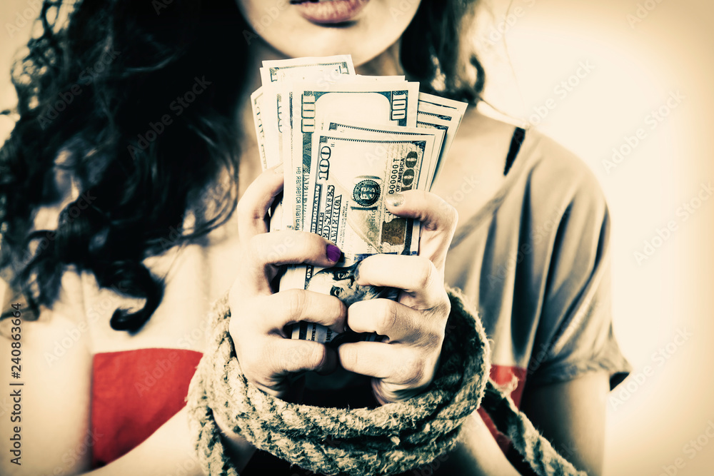Money is freedom concept. Woman's hands bound with rope as symbol of ...
