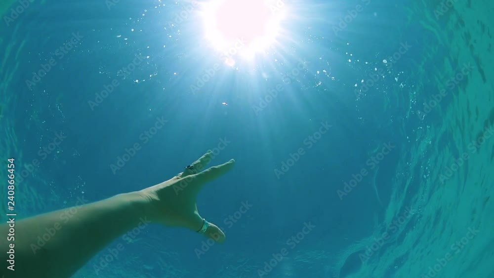 Vidéo Stock UNDERWATER, POV: Young female tourist stretching out her ...
