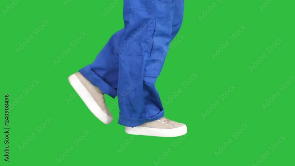 Legs of woman construction worker walking on a Green Screen, Chroma Key ...