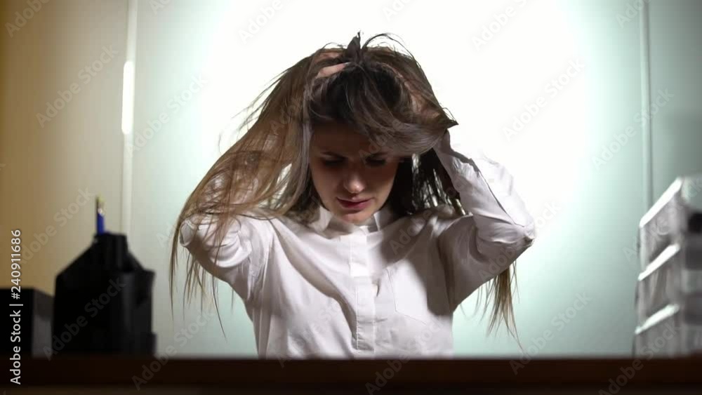 Slim sexy brunette in an office white shirt is engaged in office ...