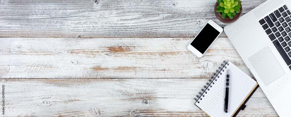 Overhead view of white rustic desk with laptop computer and work ...