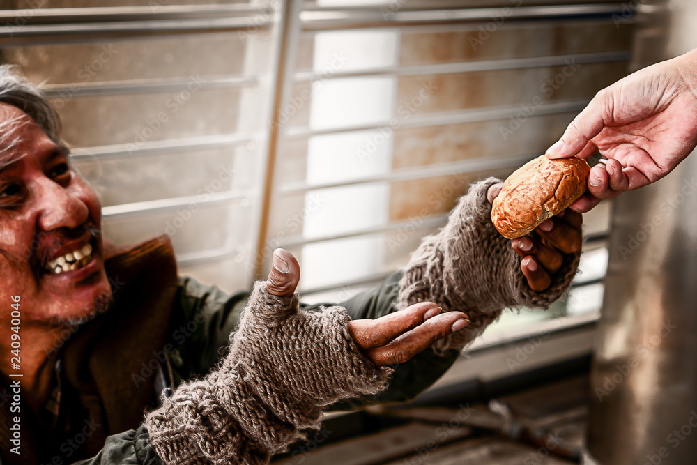mercy hand of someone give bread to poor homeless beggar who show happy ...