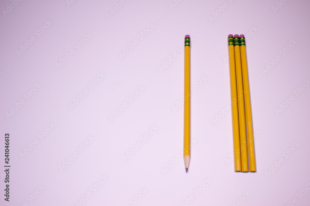 Sharpened pencil isolated by three unsharpened pencils on white ...