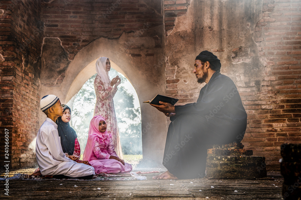 Muslim teacher teach koran to his children in old mosque Stock Photo ...