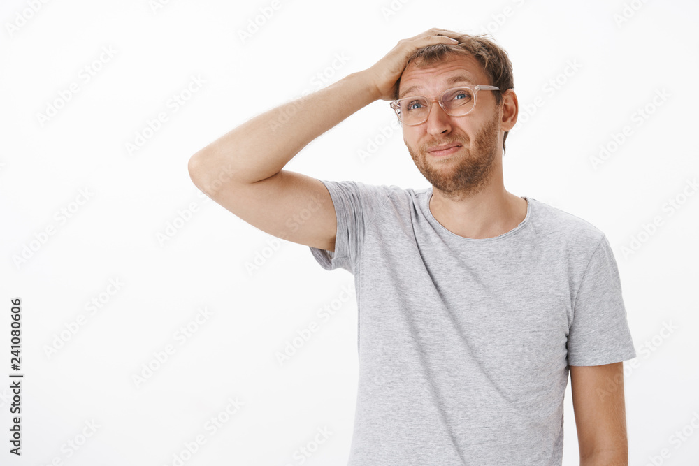 Waist-up shot of silly confused adult father with bristle in glasses ...