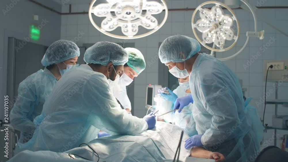 Shot of a multiracial surgeon team consists of trained surgeons, trauma ...