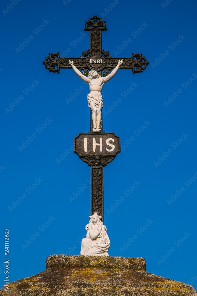 Christian black iron crucifix with white sculpture of Jesus Christ ...
