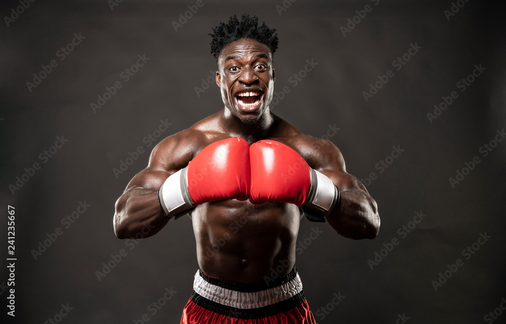Muscular African American Black male sweaty boxer does an aggressive ...
