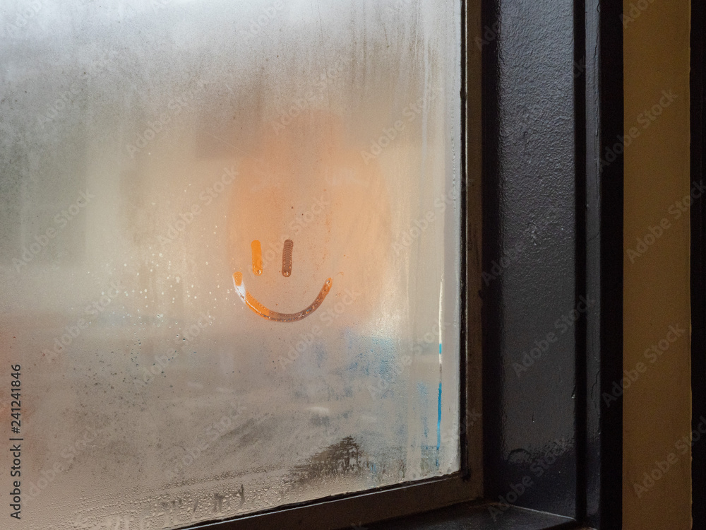 Smiley face drawn in condensation and foggy window in restaurant Stock ...