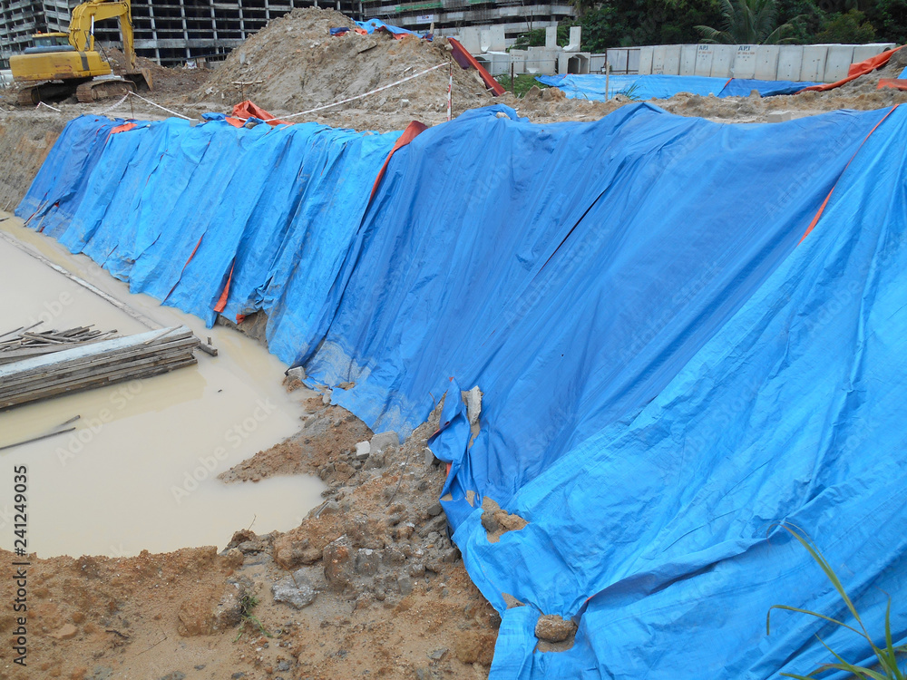 Temporary slope protection using huge plastic sheet at the construction ...