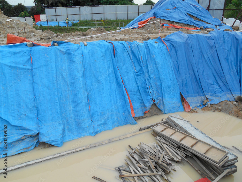 Temporary slope protection using huge plastic sheet at the construction ...