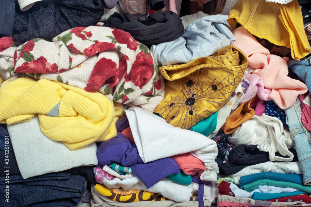 Pile of messy clothes in closet. Untidy cluttered woman. Stock Photo ...