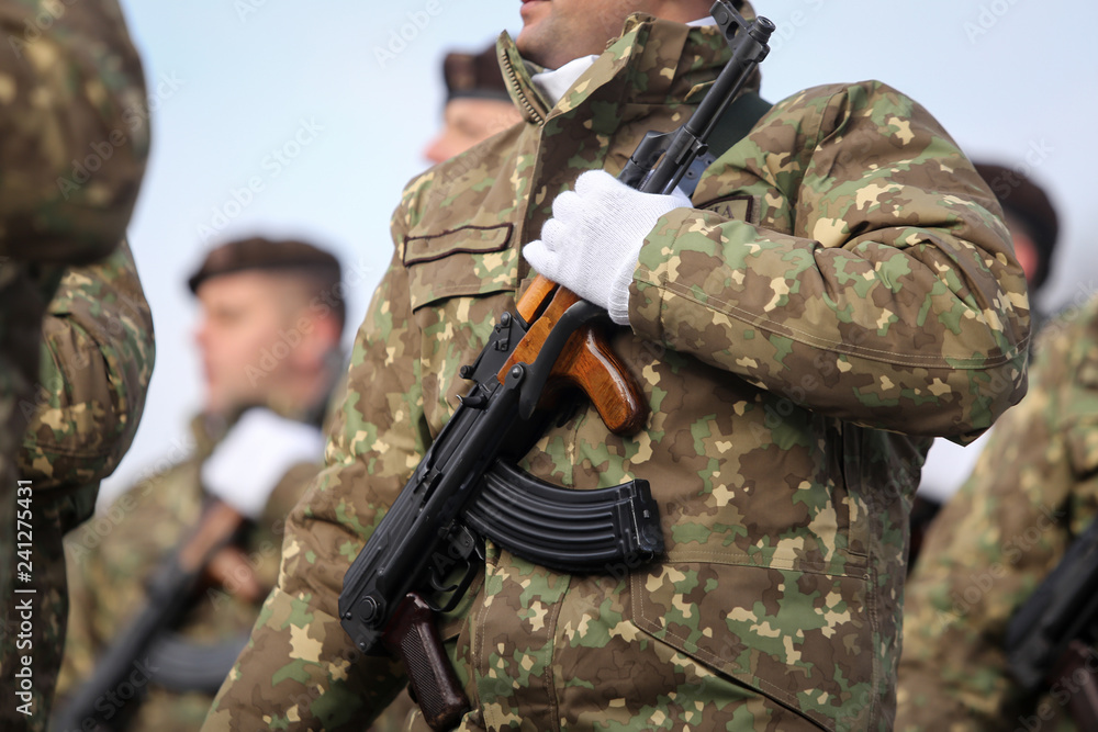 Romanian army soldiers are armed with AK-47 assault rifles Stock 写真 ...