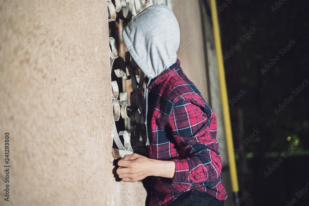 evil criminal rob the house and enter it through window at night b ...