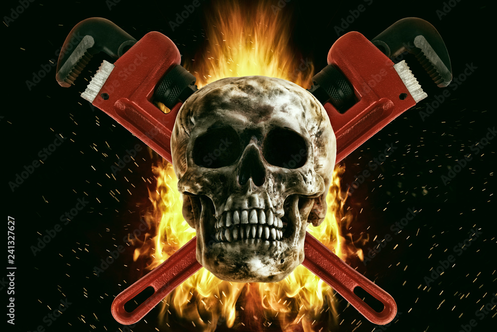 Skull and wrench on fire on a black background. Photo manipulation ...
