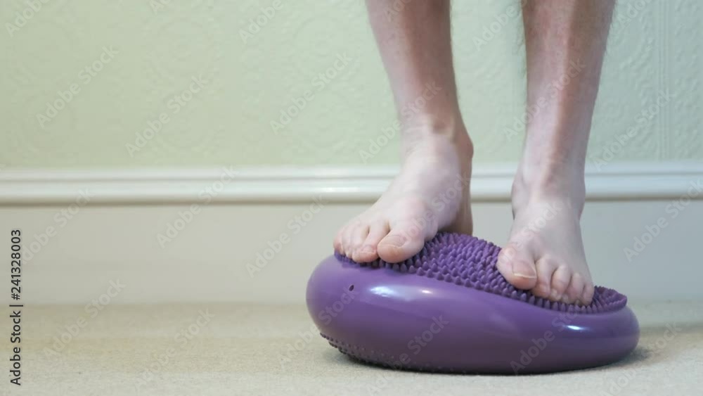 Balance board ankle exercise purple inflatable wobble feet close up ...
