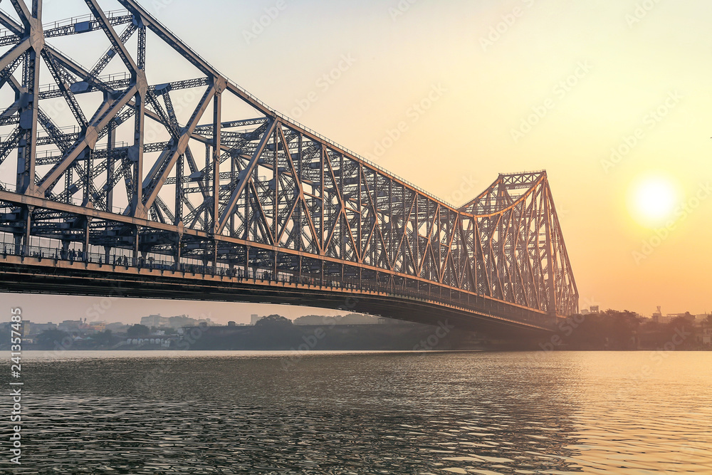 Howrah bridge Kolkata on river Ganges at sunrise with winter haze ...
