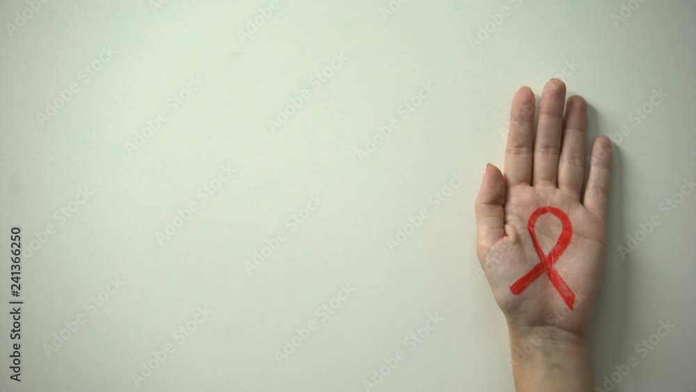 Female hand with red ribbon sign, AIDS and HIV awareness and prevention ...