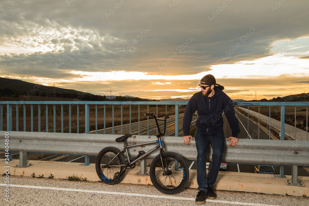 BMX rider with his bmx bike on the street. Guy riding in bmx Stock ...