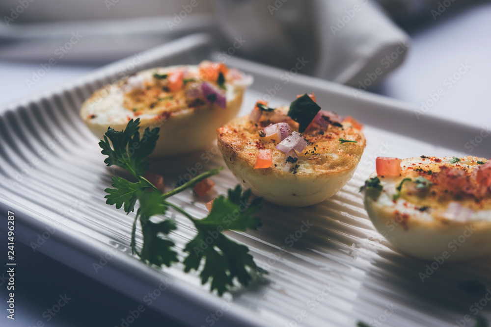 Fried hot boiled egg masala is a popular healthy breakfast or starter ...