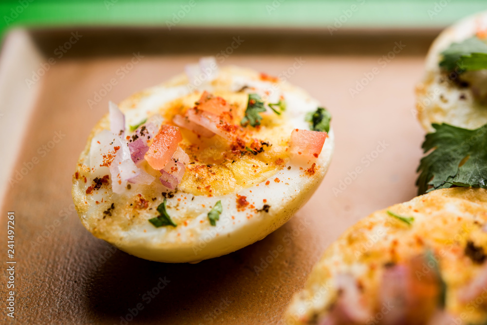 Fried hot boiled egg masala is a popular healthy breakfast or starter ...