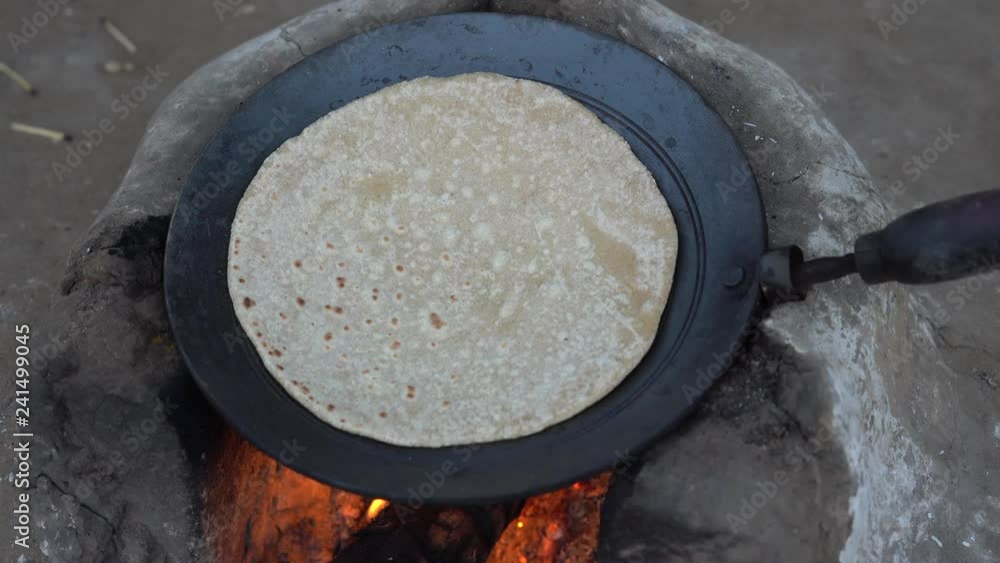 Indian girl cooking traditional indian bread, close-up hands and ...