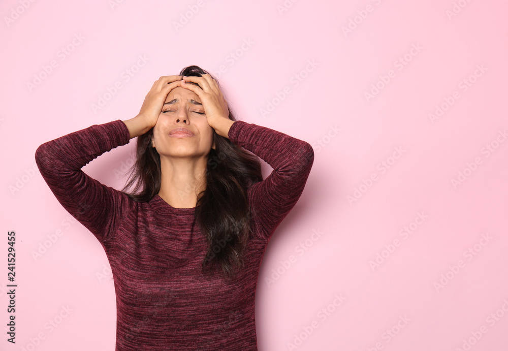Stressed young woman on color background Stock Photo | Adobe Stock