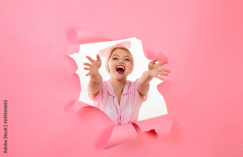 Pin up woman peeks through paper. Pin up girl. Woman breaks paper ...