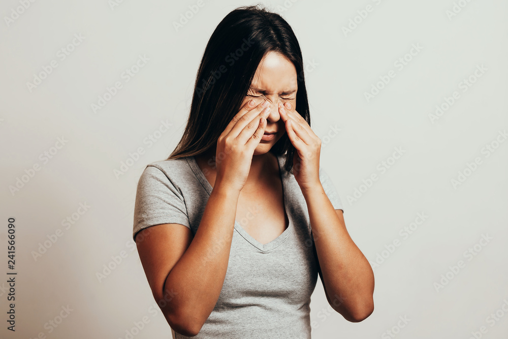Sinus pain, sinus pressure, sinusitis. Sad woman holding her nose and ...