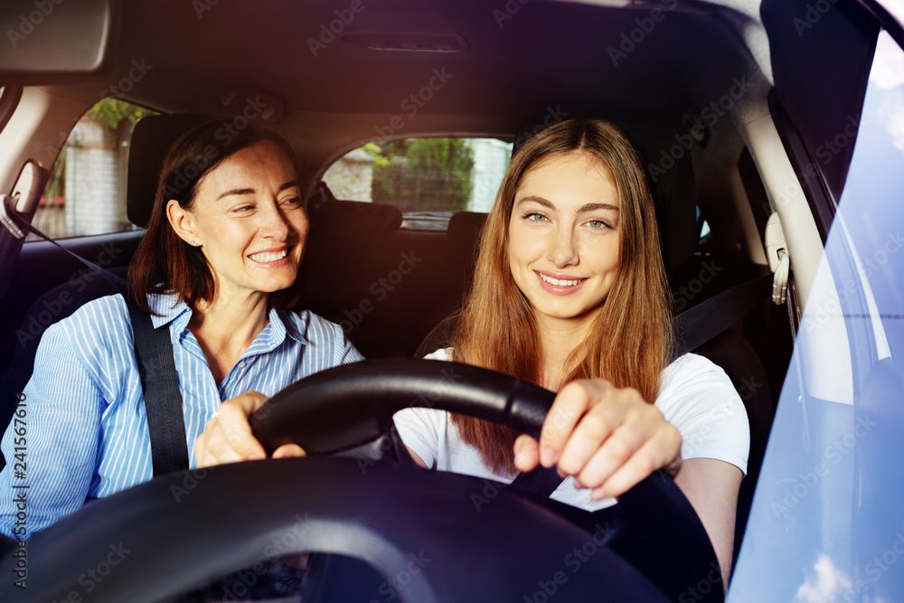Happy adult daughter driving her mother in car Stock Photo | Adobe Stock