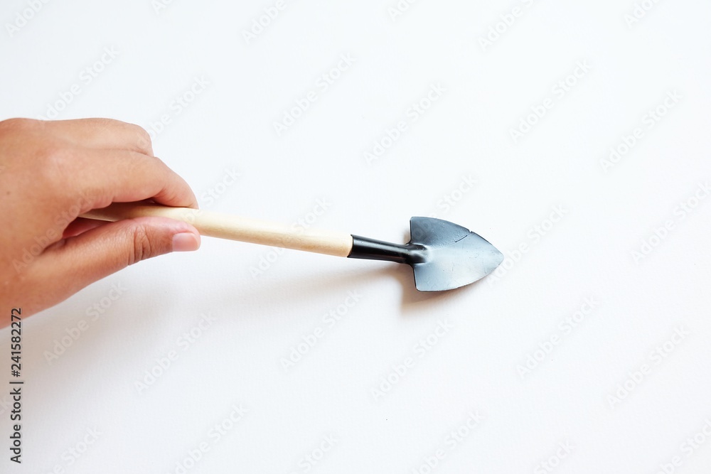 Hand holding a metal shovel with separate wood handle, farm tool ...