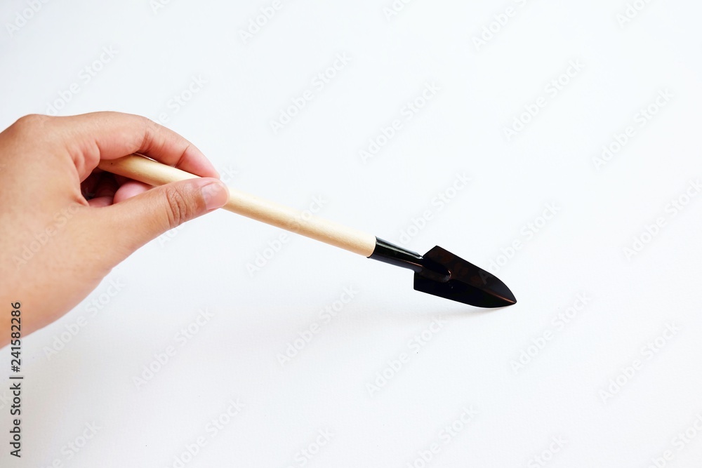 Hand holding a metal shovel with separate wood handle, farm tool ...