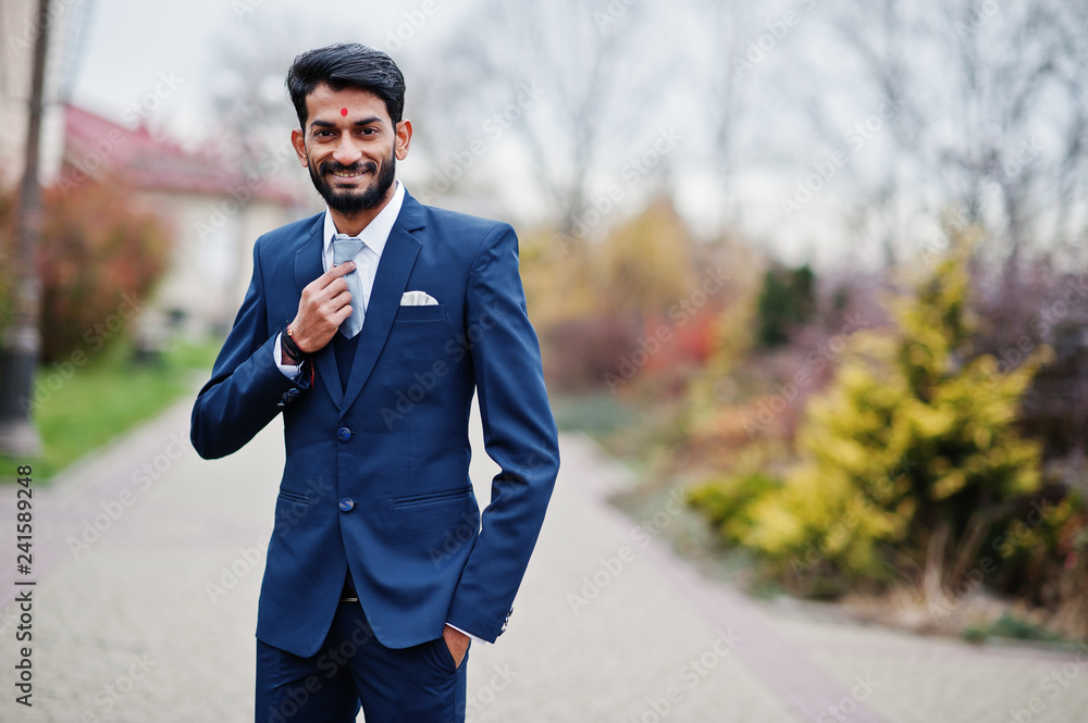 Stylish beard indian man with bindi on forehead, wear on blue suit ...