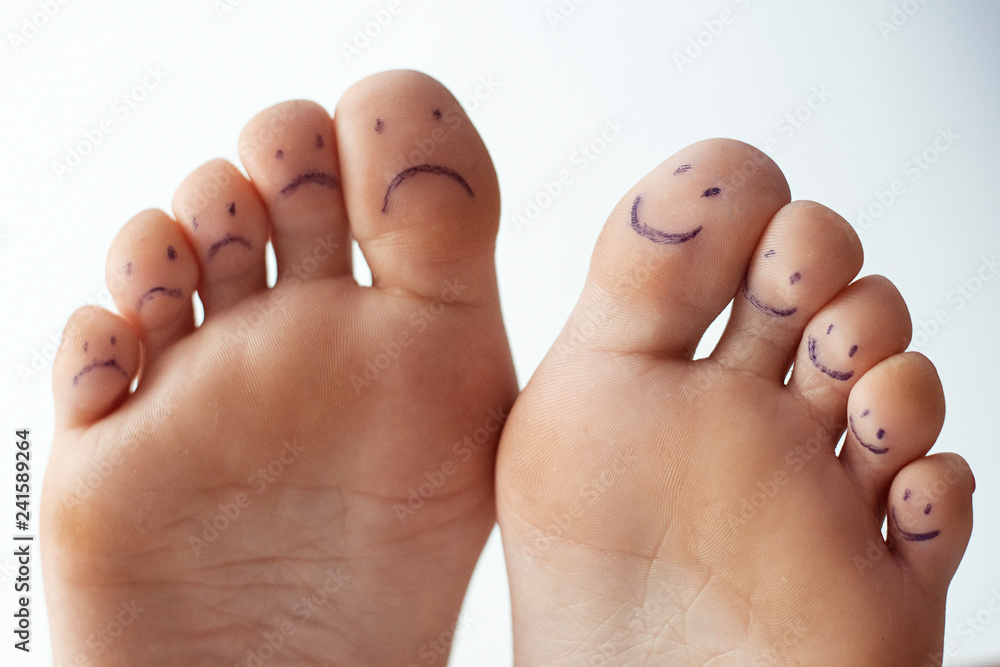 Female toes with painted smileys. Foot care concept. Stock Photo ...