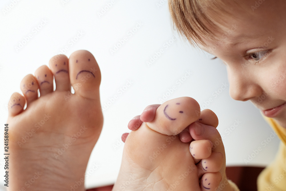 Female toes with painted smileys and baby. Foot care concept, pedicure ...