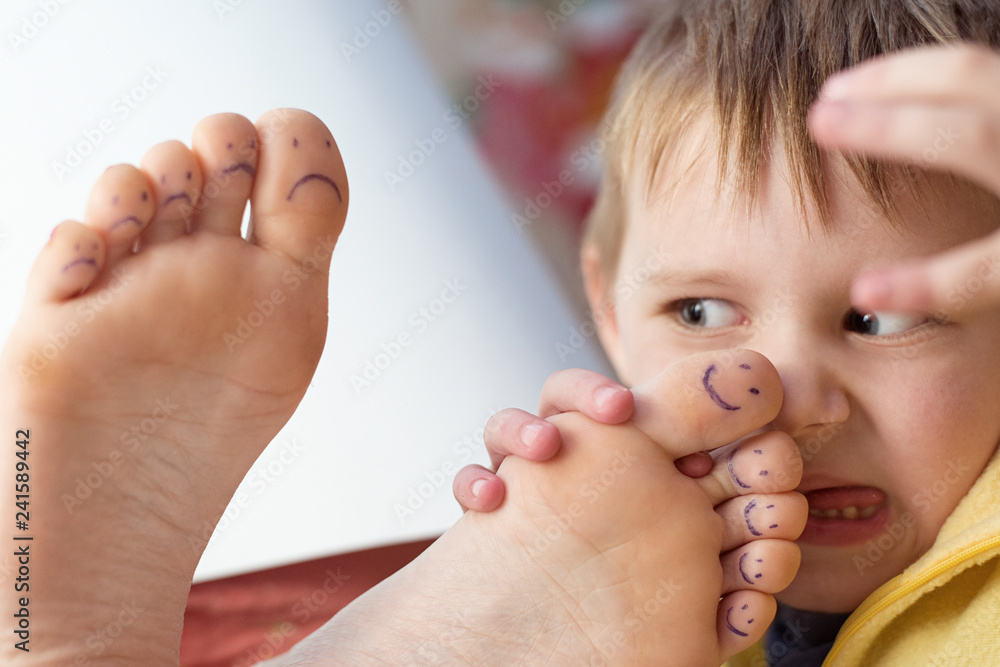 Female toes with painted smileys and baby. Foot care concept, pedicure ...