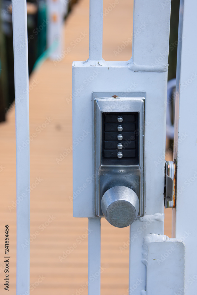 Locked private metal security gate door with pushbutton combination ...