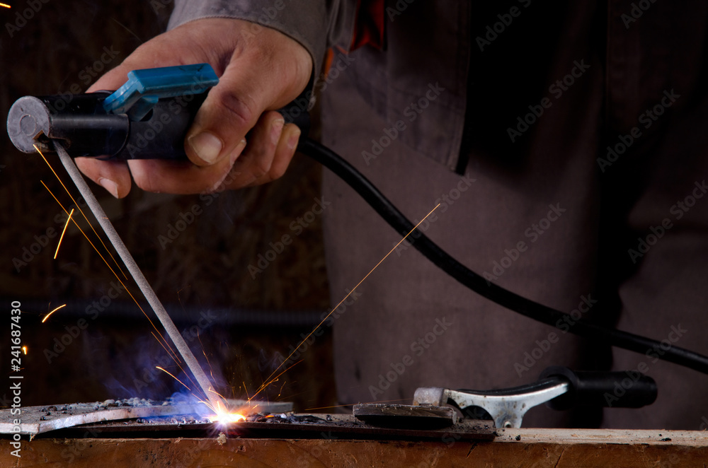 Mans hand with welding machine Stock Photo | Adobe Stock