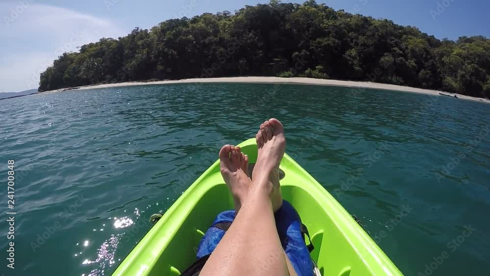 female feet relaxing on kayak sailing in pacific ocean point of view ...