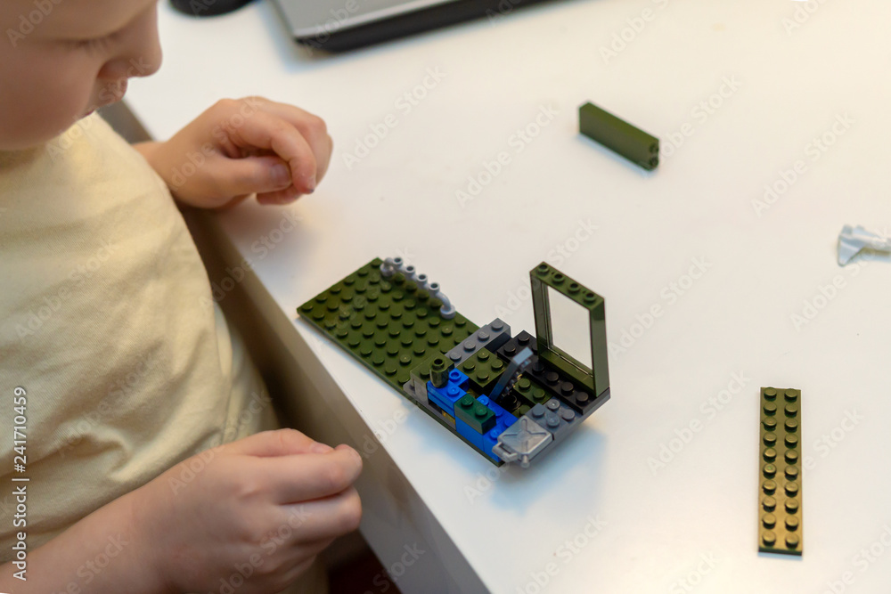 Little boy playing with constructor in the room. The concept of ...