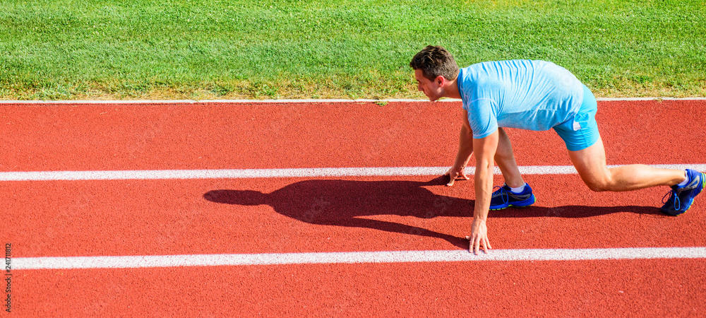 Sport motivation concept. Man athlete runner stand low start position ...