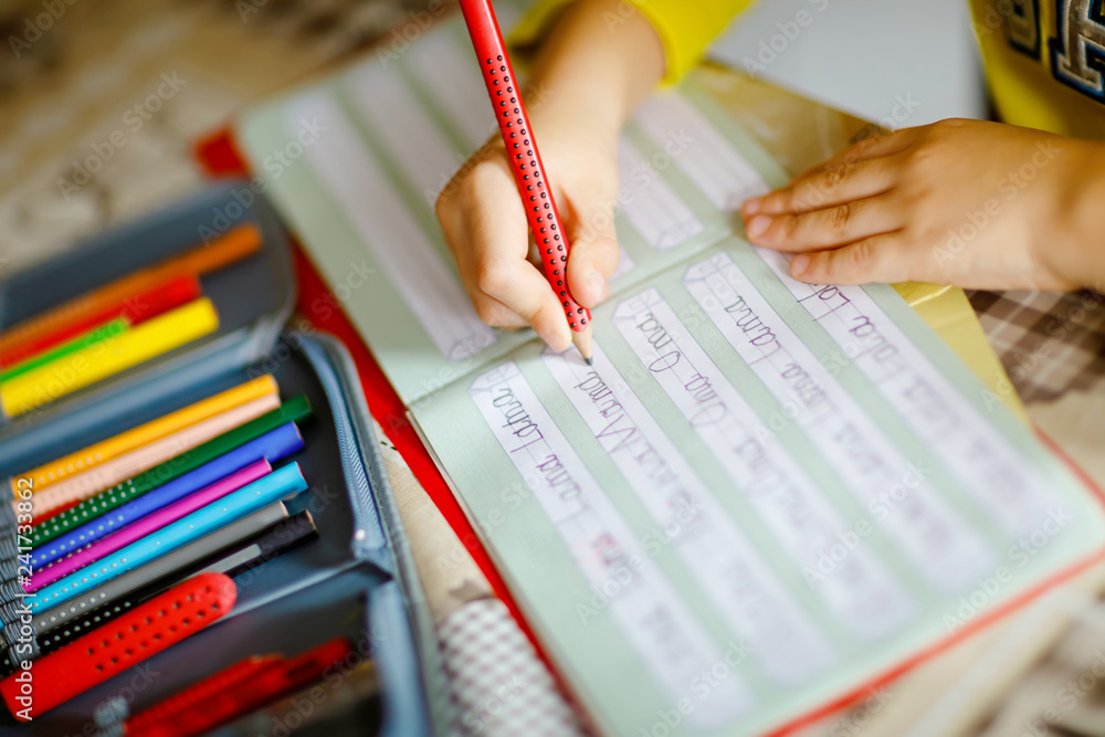 lose-up of little kid boy at home making homework, child writing first ...