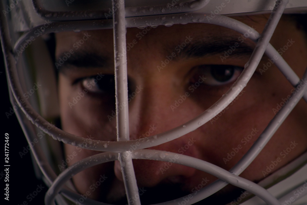 Detail of a male face in a goalie hockey mask.This is a detail hockey ...