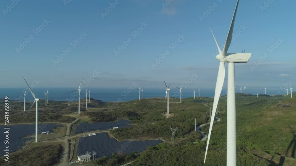 Aerial view windmills for electric power production on seashore. Bangui ...