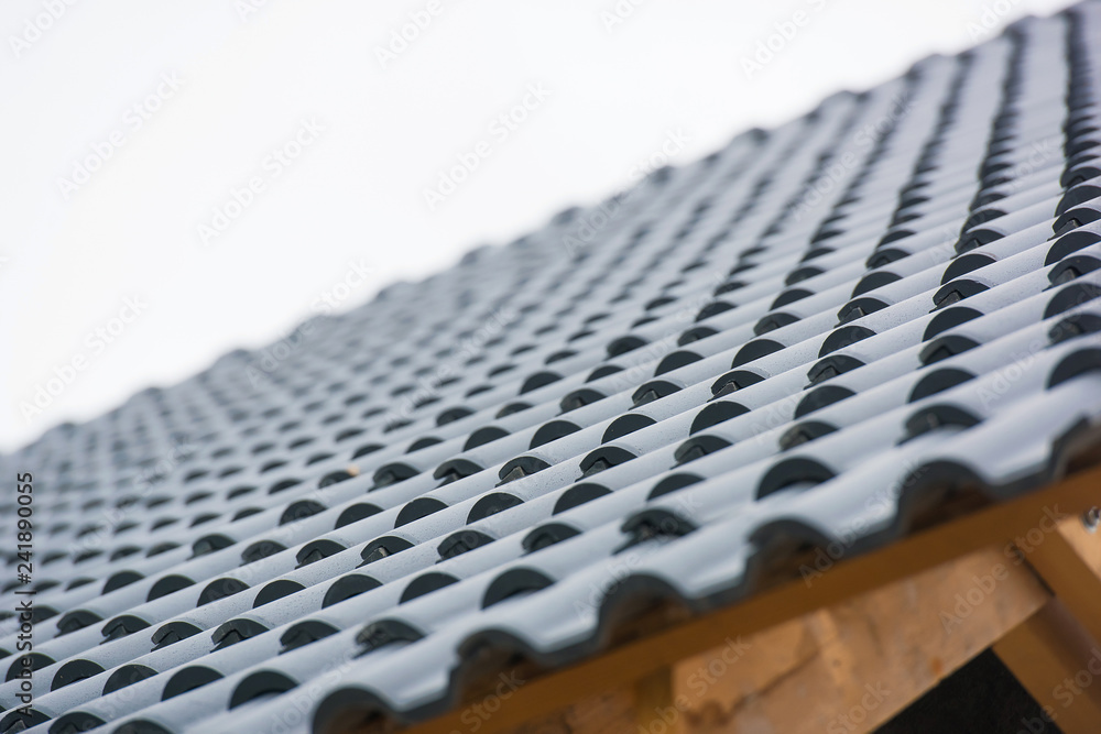 Building a house with a tiled roof. Directing wooden roof beams. Gray ...