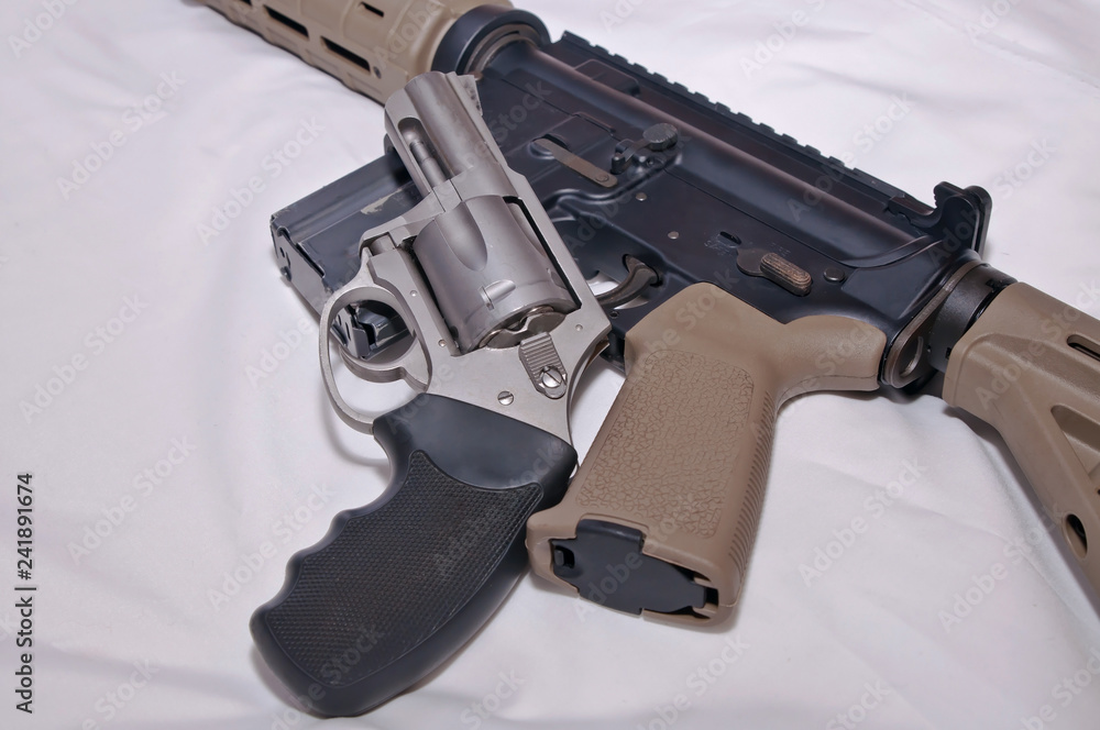 A stainless steel 357 magnum revolver with a black grip on top of a ...